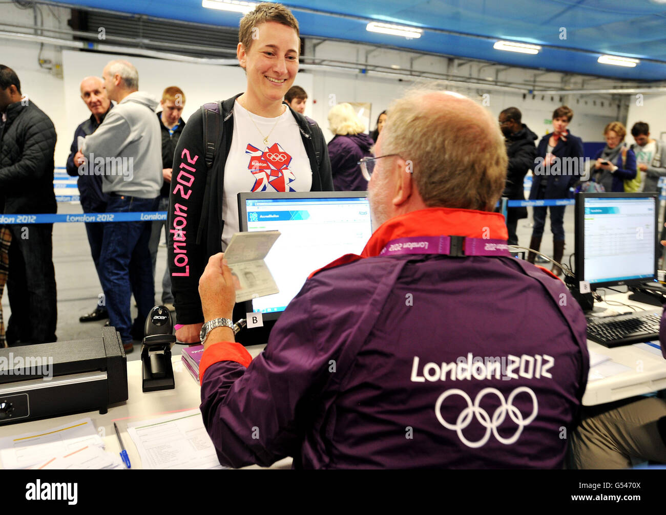 Fabienne Coulon from Belgium waits to be processed for her pass and ...