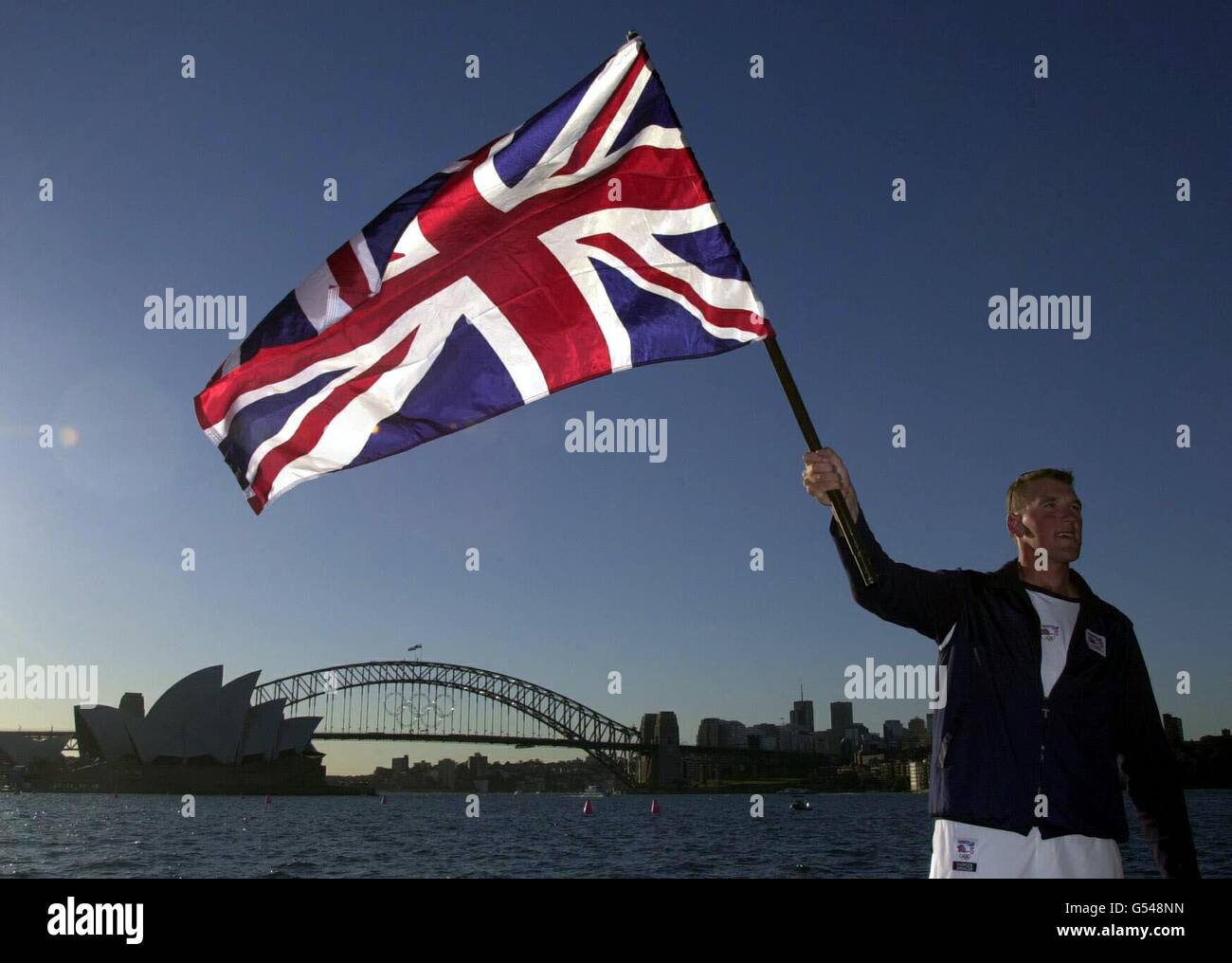 Rower Matthew Pinsent raises the Union Flag over Sydney Harbour ...