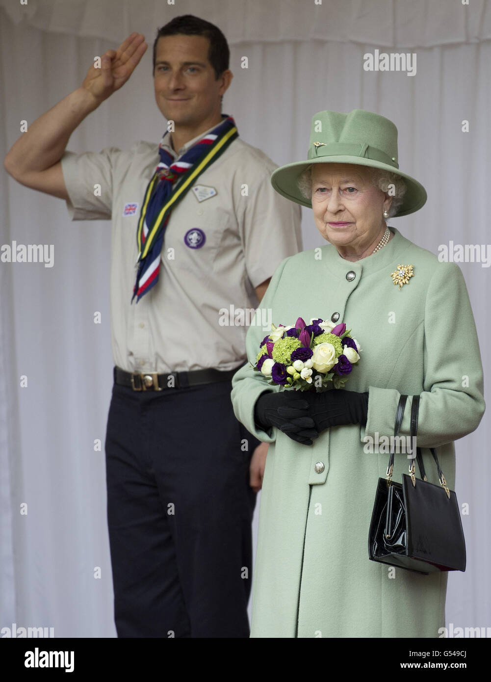 Chief Scout, Bear Grylls, left, salutes as Queen Elizabeth II reviews ...