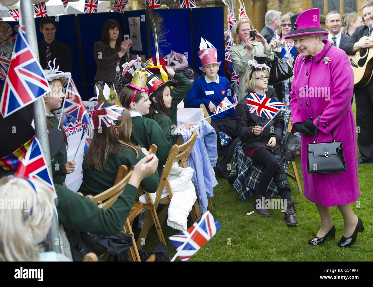 Queen Elizabeth II meets school children at a Mad Hatter's Tea Party in ...