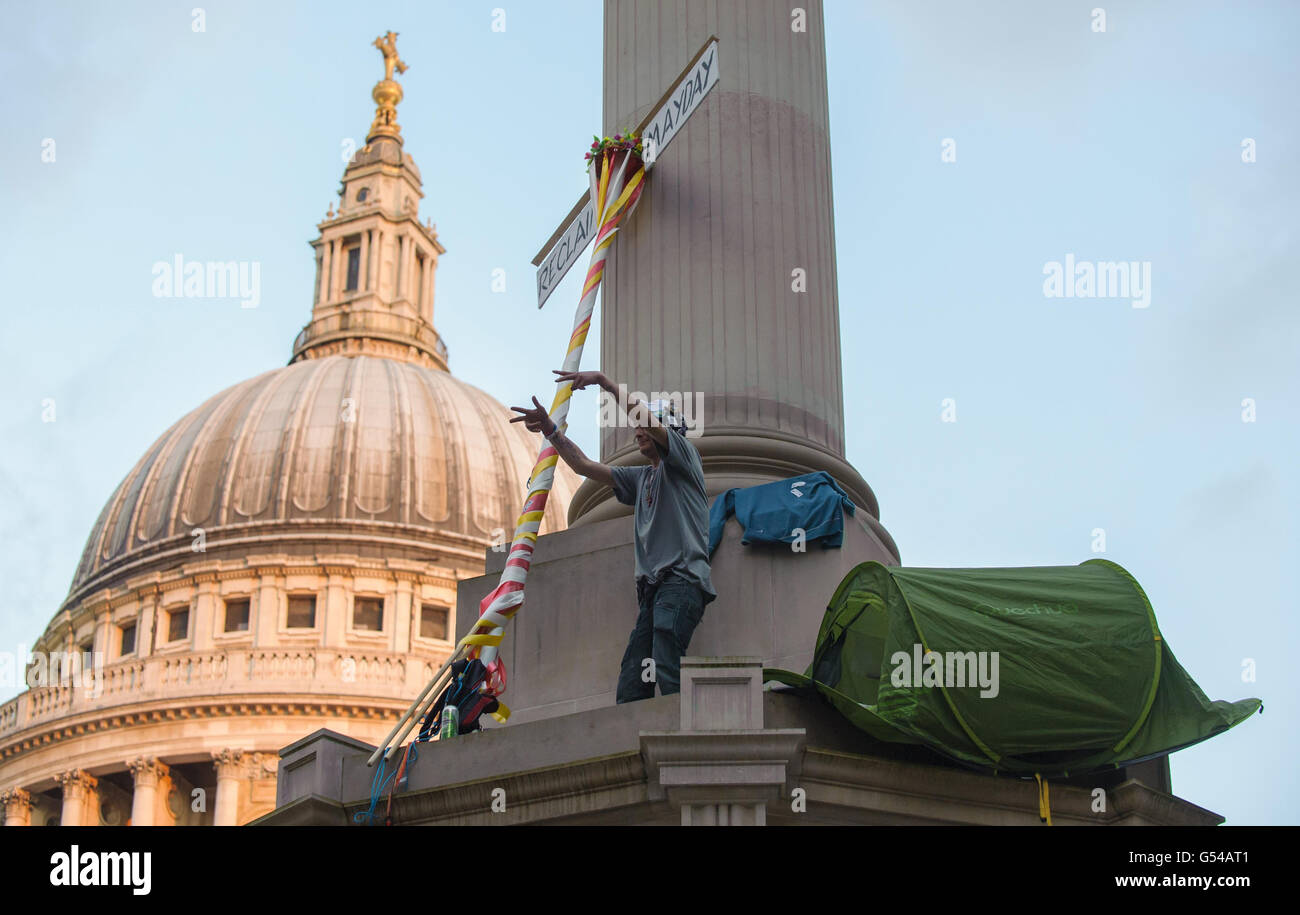 May day demonstrator on top of statue in paternoster square hi-res ...