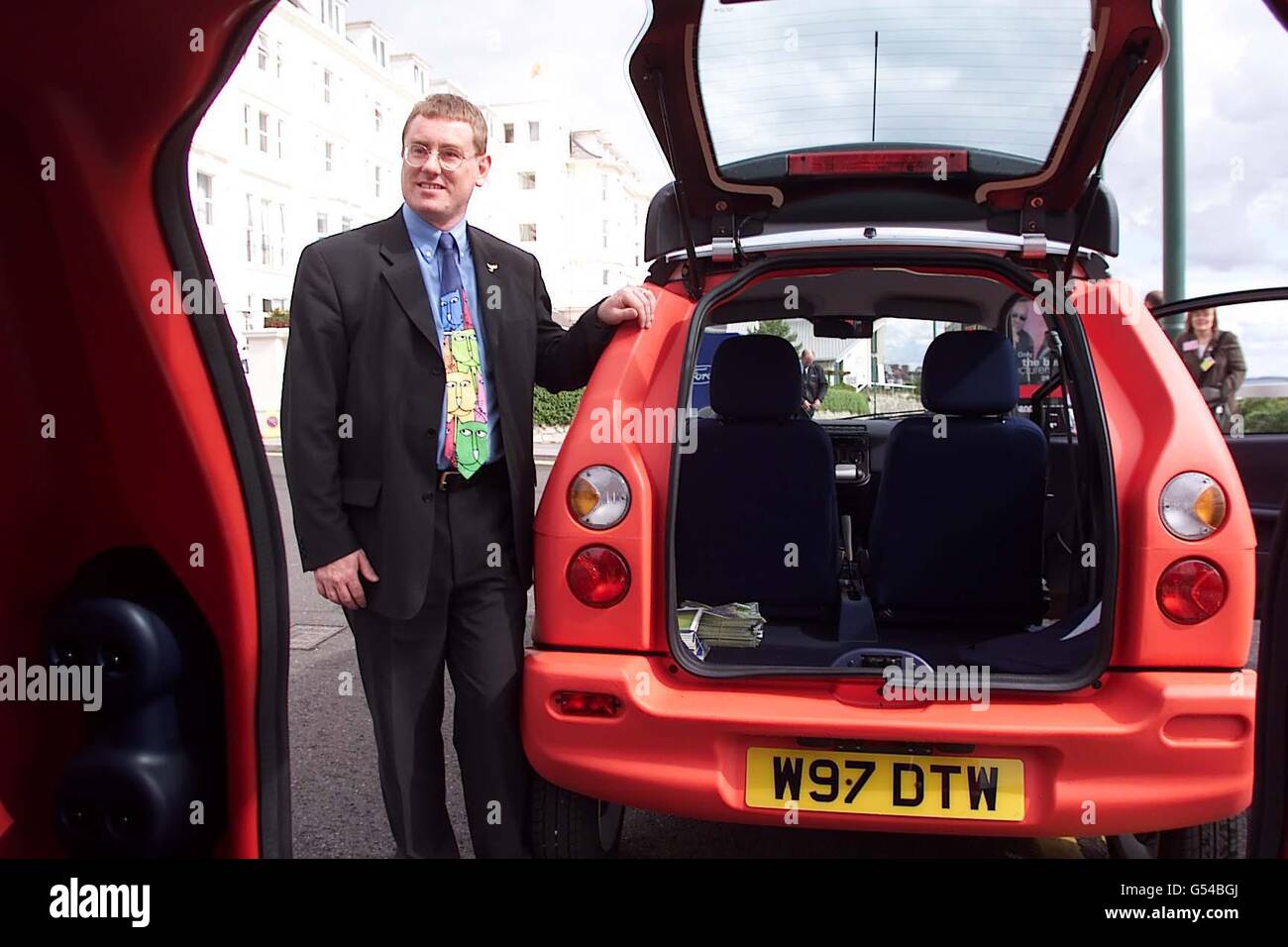 Welsh Assembly Member Peter Black with a battery powered Ford Think car ...