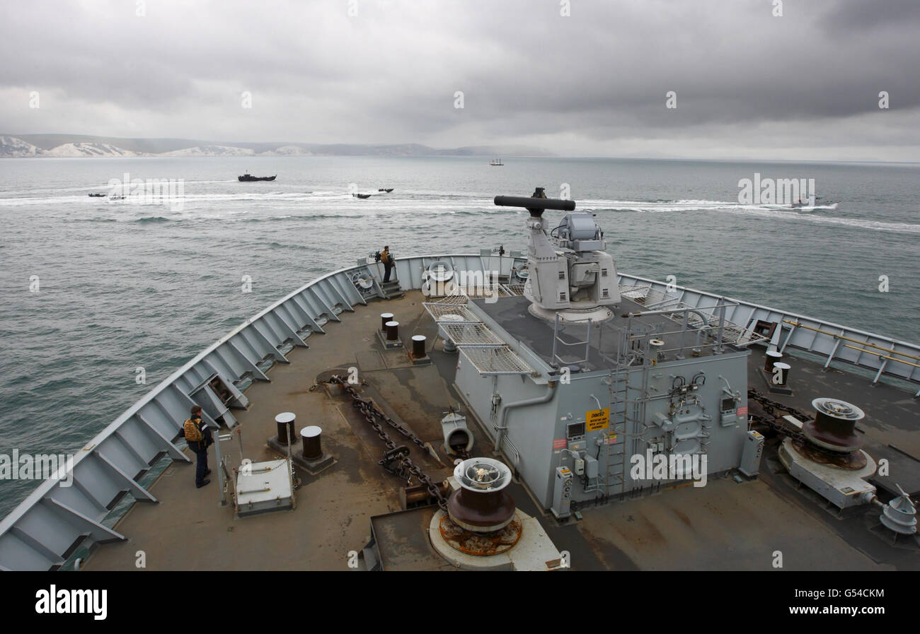 Sailors aboard the Royal Navy flagship HMS Bulwark, watch as Royal ...
