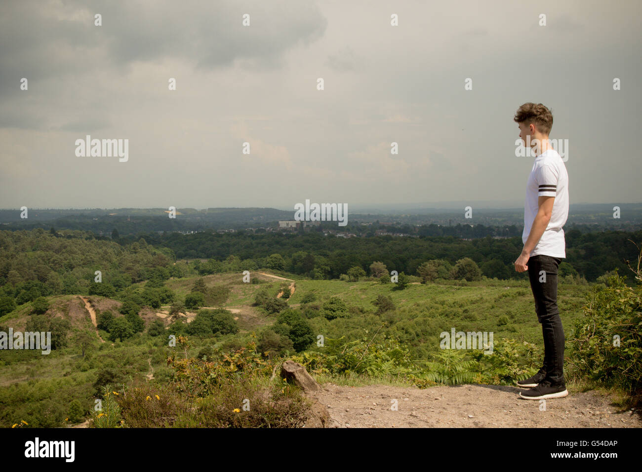 Teenage boy looking over landscape Stock Photo - Alamy