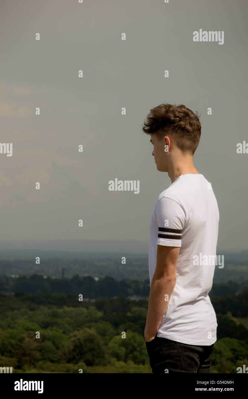 Teenage boy looking over landscape Stock Photo - Alamy