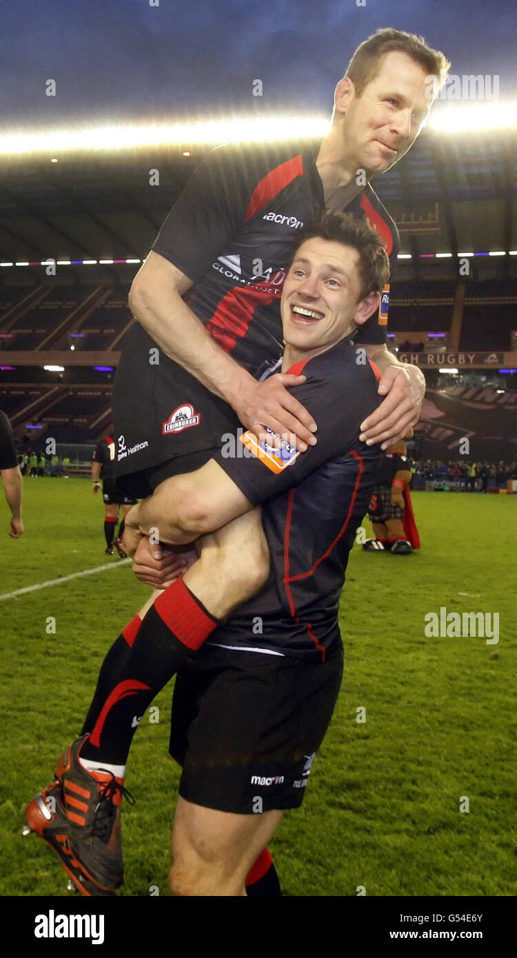 Edinburgh's Chris Paterson is picked up by Nick De Luca following his ...