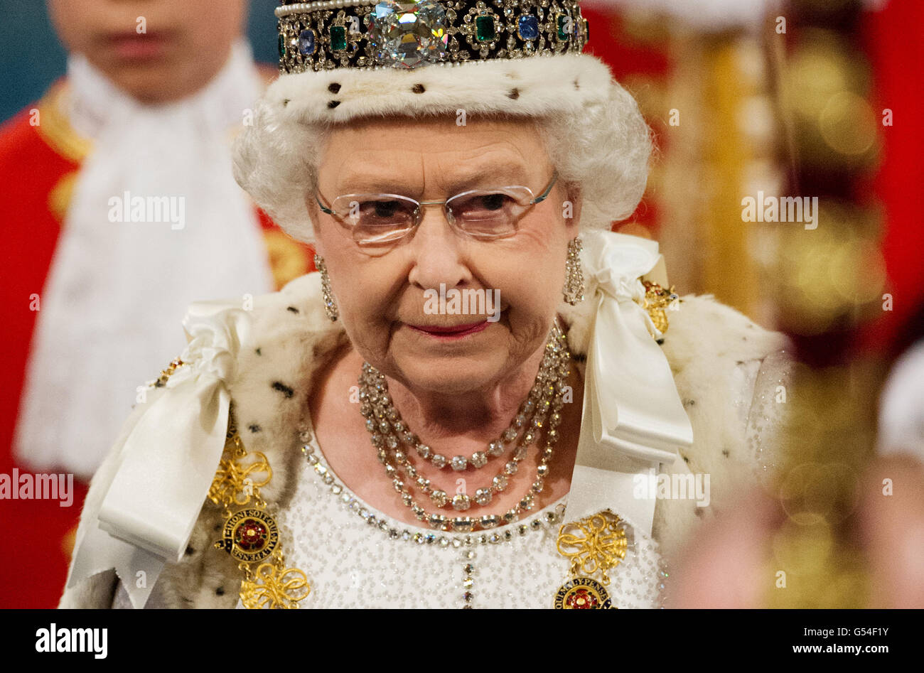 Queen Elizabeth II wearing the Imperial State Crown walks through the ...
