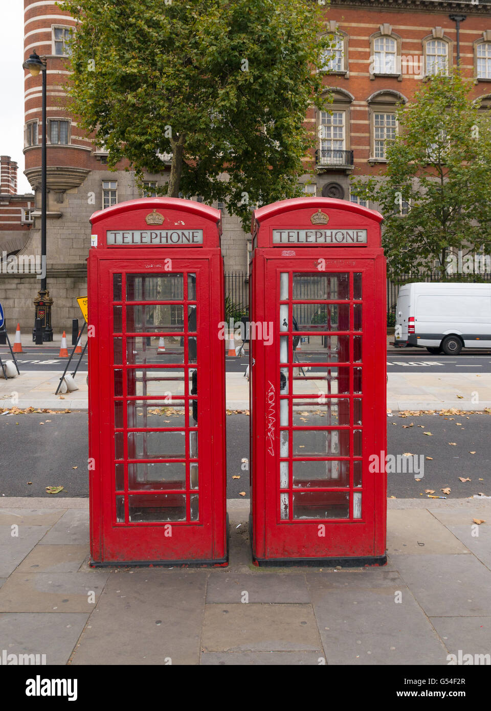 Two typically english red phone booths in London Stock Photo - Alamy