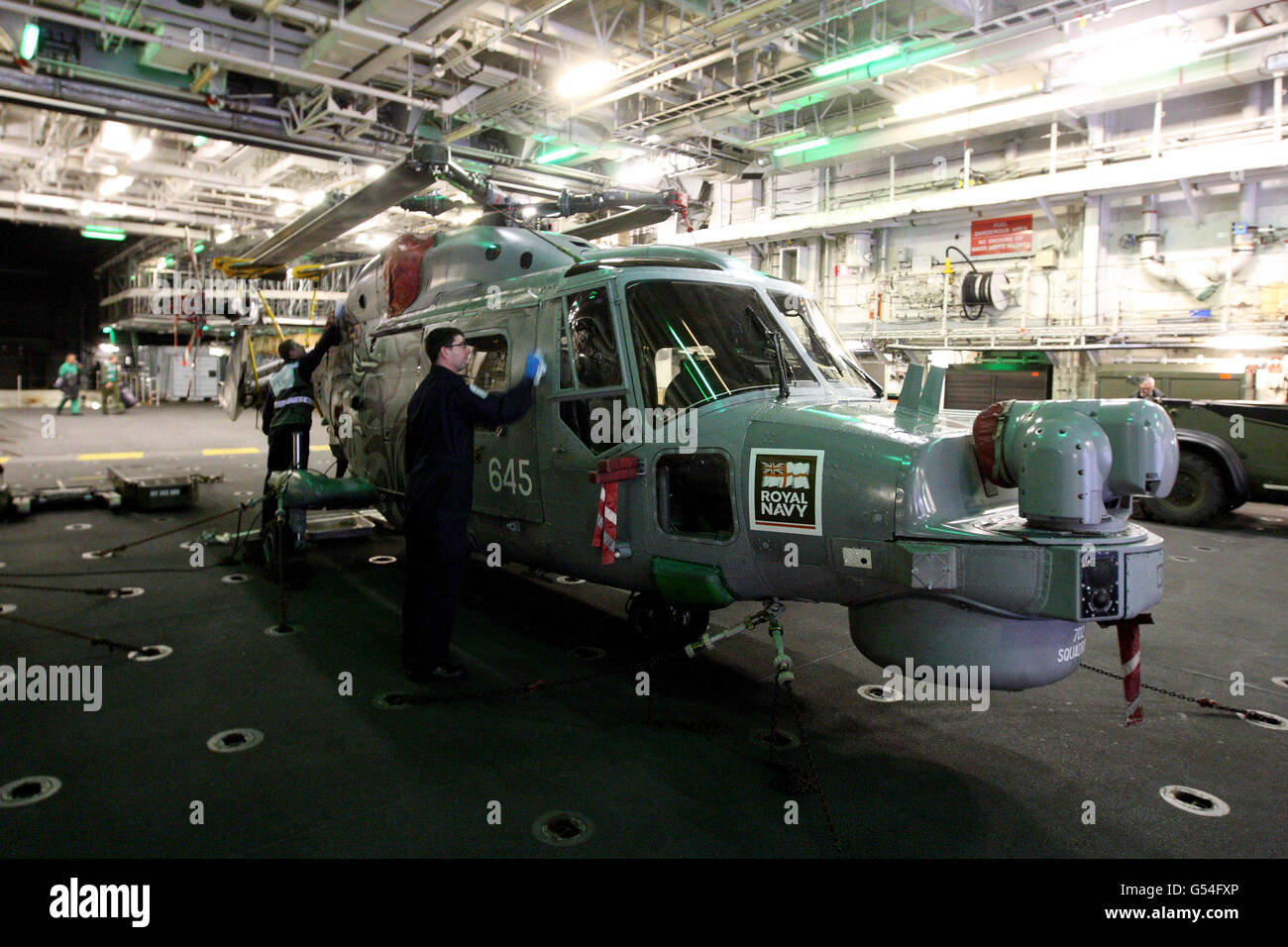 Engineers clean and repair a Lynx Helicopter onboard HMS Ocean Stock ...