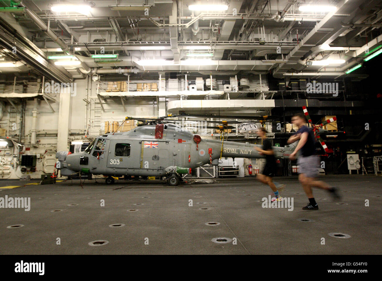 Royal Naval personnel go through exercise in front of a Lynx Helicopter ...