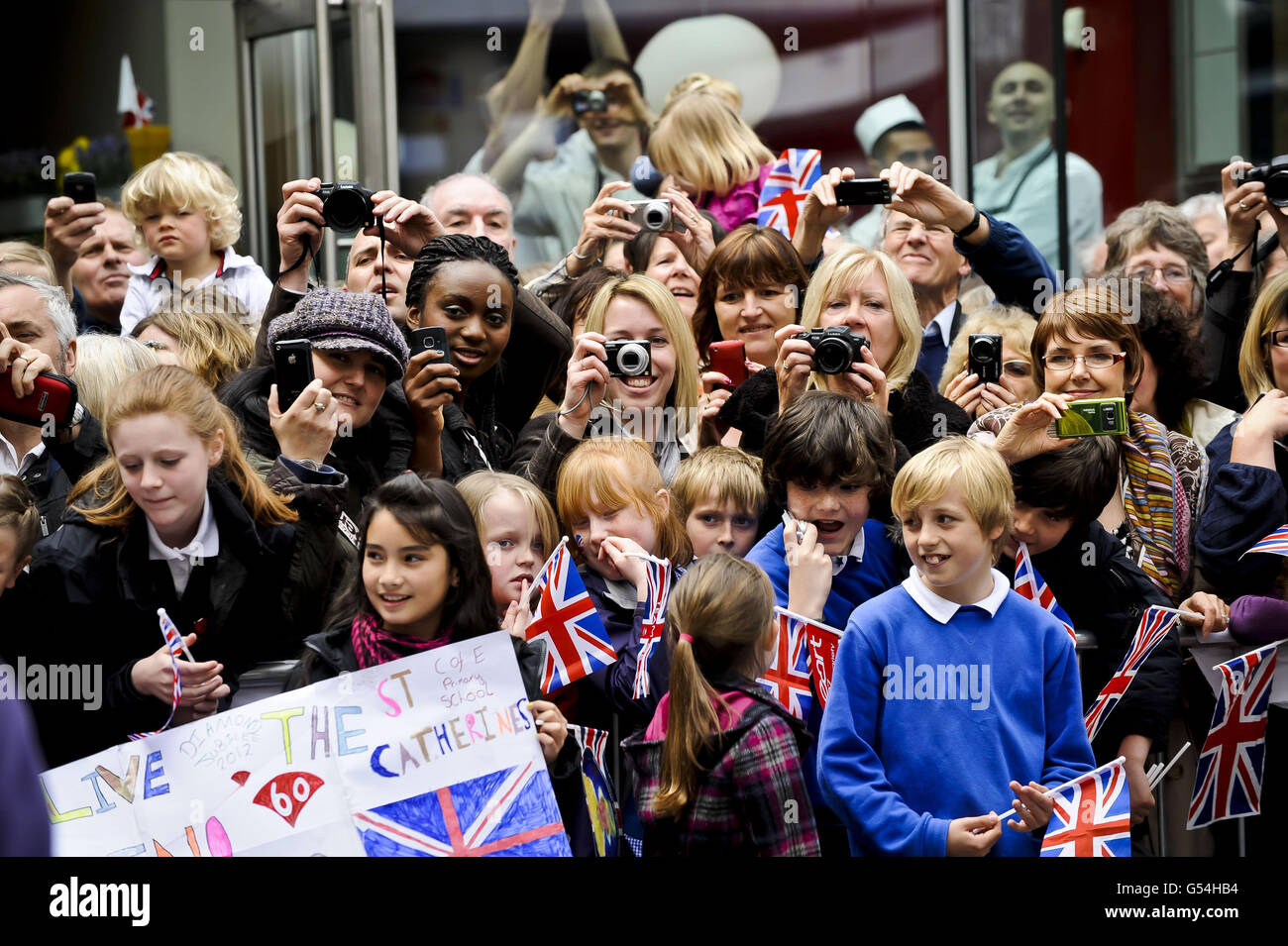 Crowds in Exeter city centre take photographs of Queen Elizabeth II and ...