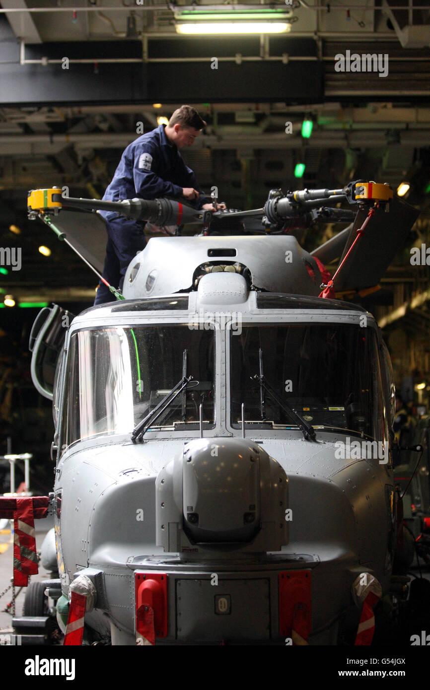 AET Iain Bailey works on a Lynx helicopter onboard HMS Ocean as it ...