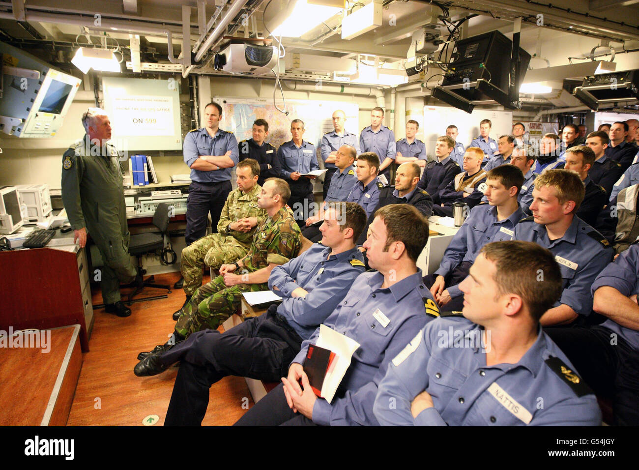 Army and Navy personnel during a briefing onboard HMS Ocean as it heads ...