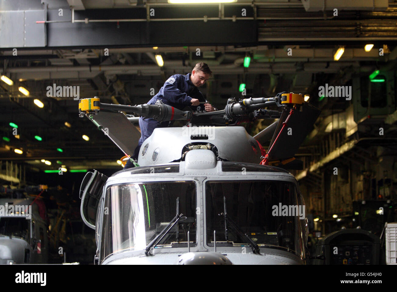 AET Iain Bailey works on a Lynx helicopter onboard HMS Ocean as it ...