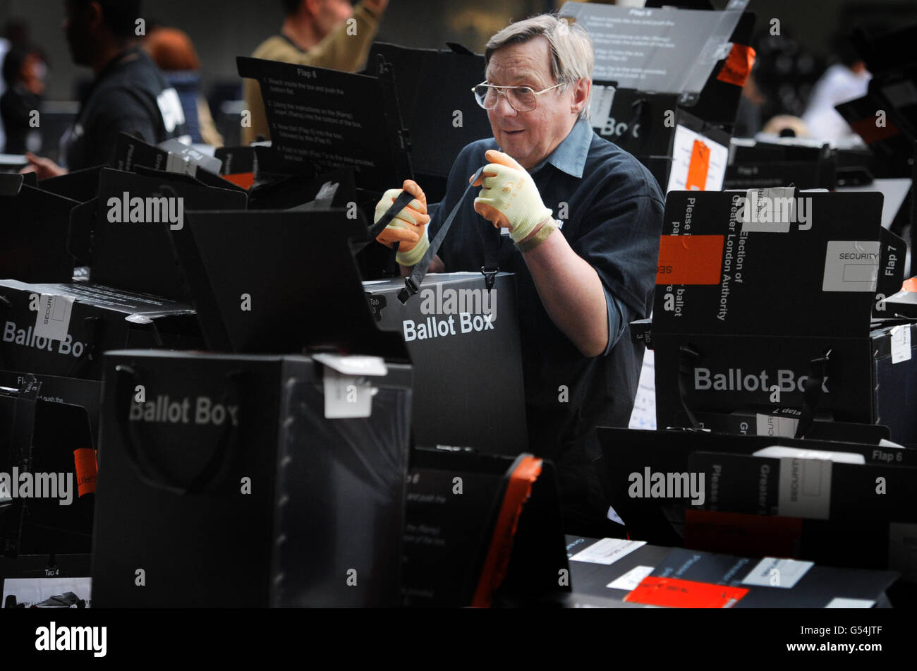 Counting staff at Olympia in London prepare to count the votes from ...