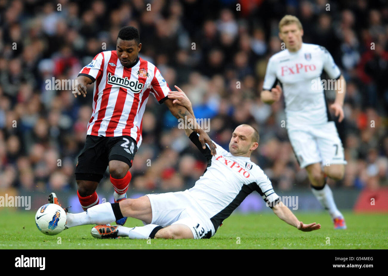 Fulham's Danny Murphy tackles Sunderland's Stephane Sessegnon (left ...