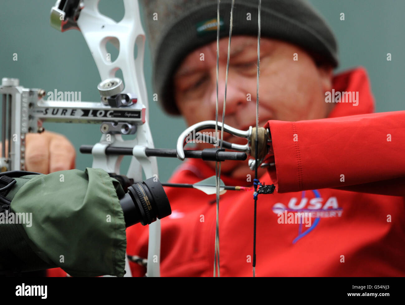 USA's Charles (Chuck) Lear, who lost his arm in Vietnam, loads an arrow ...