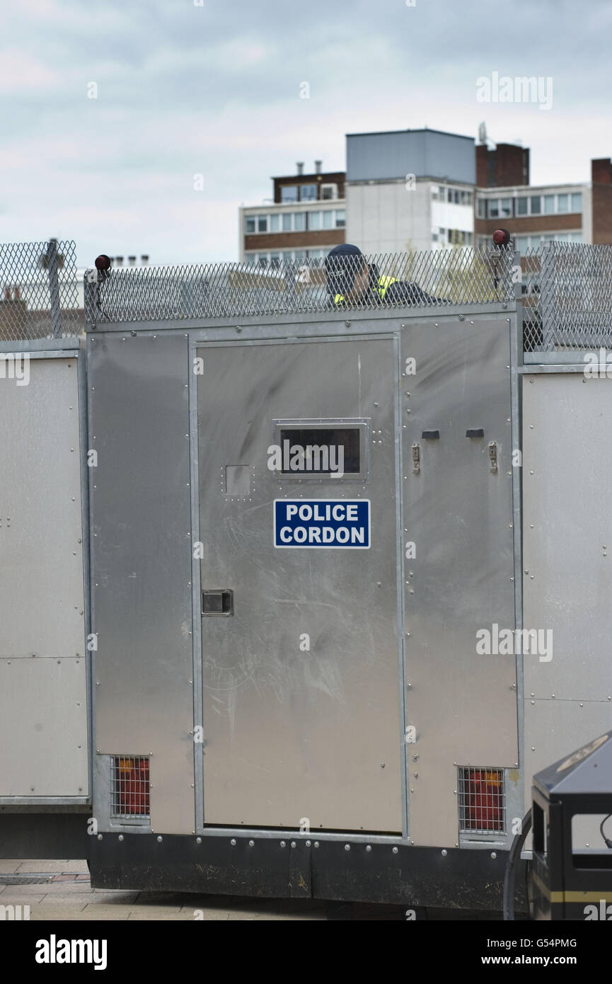 Police erect a portable steel barrier to cordon off no-go areas during ...