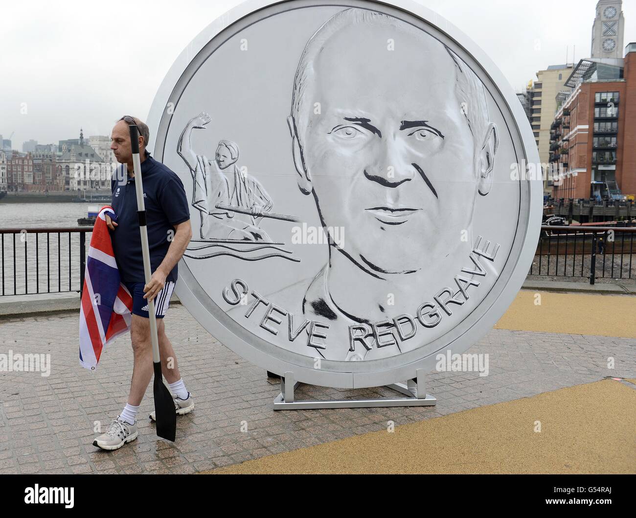 Sir Steve Redgrave stands in front of a giant medallion, featuring his ...