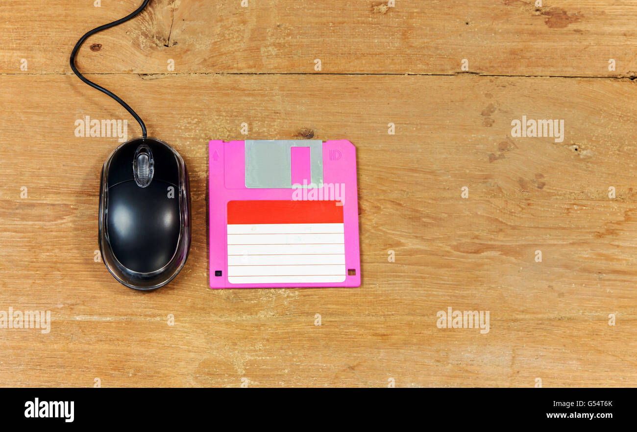 Black wired computer mouse and floppy disk on wood table Stock Photo ...