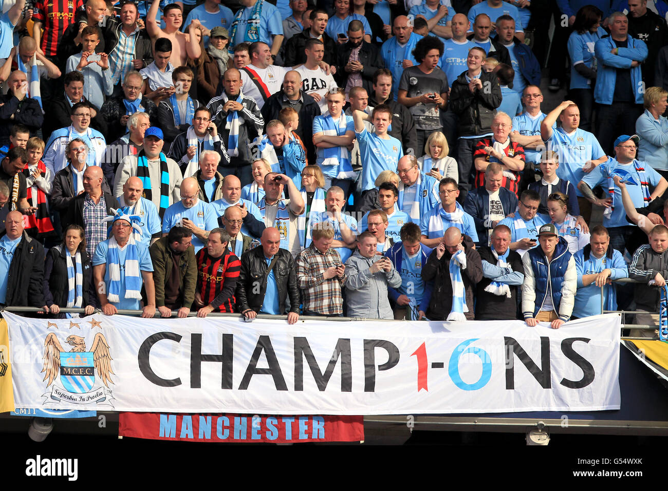 Manchester City fans with a 'Champions' banner in the stands Stock ...