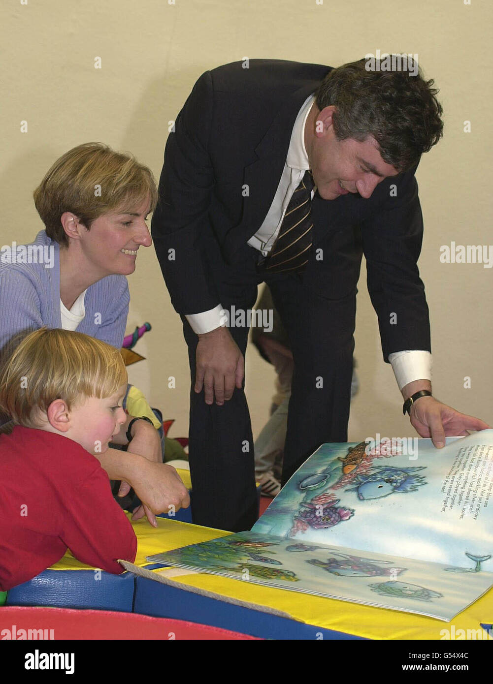 Politics with child smiling reading childrens book gordon brown hi-res ...