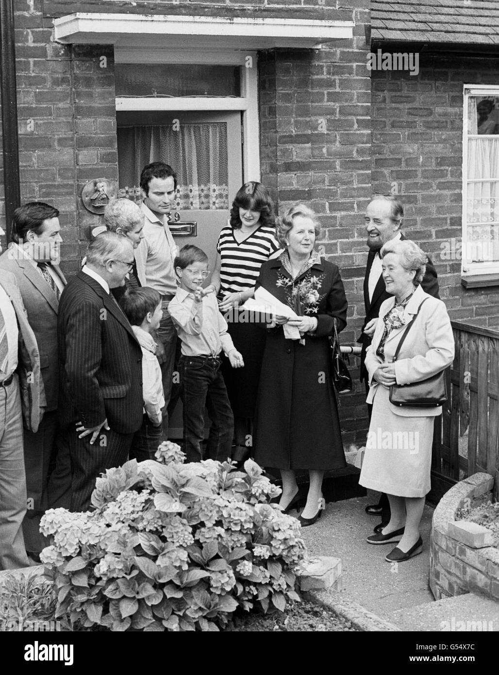 Prime Minister Margaret Thatcher, 3rd right, hands over a copy of the ...