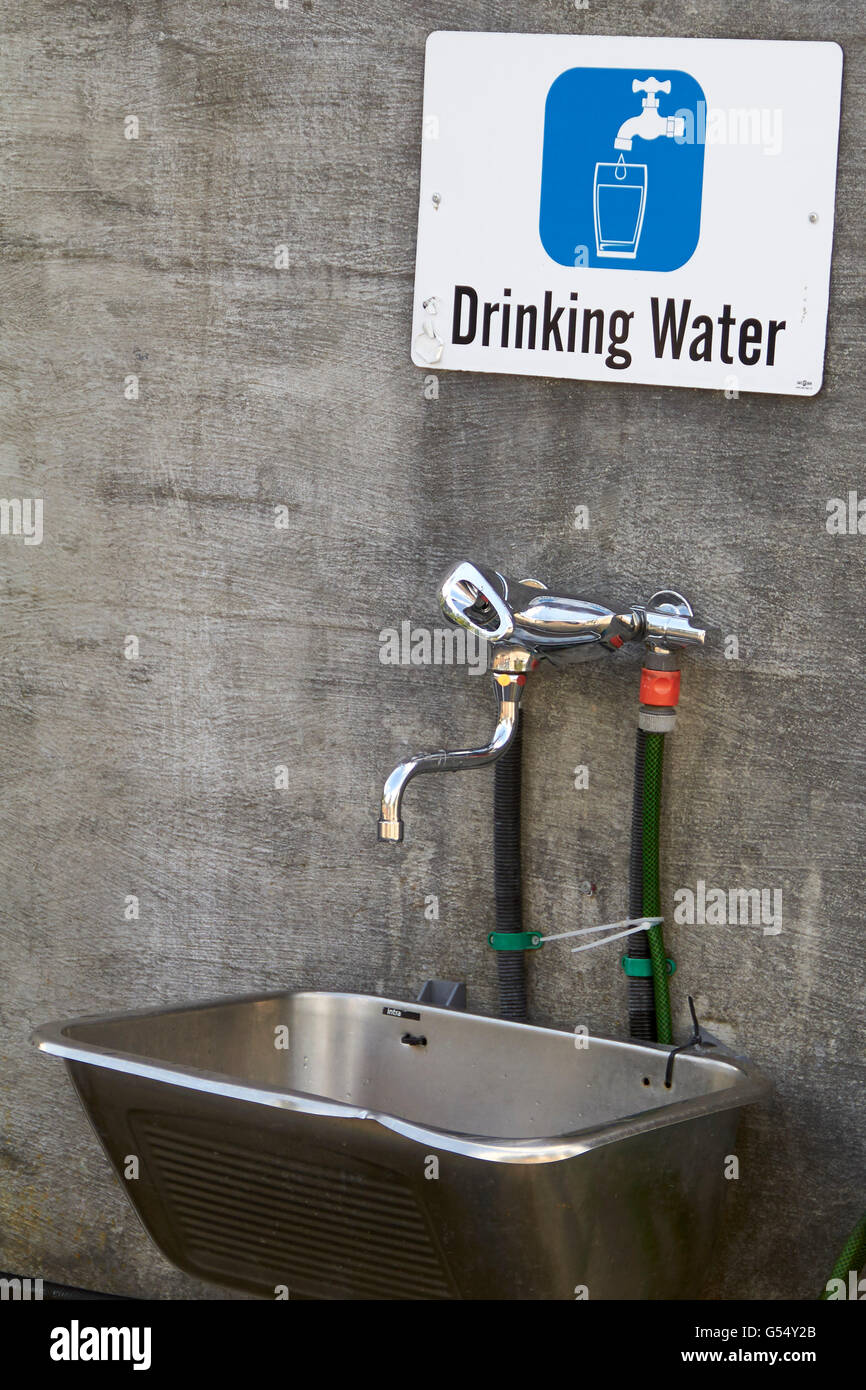 Drinking water outlet and sign on camping ground Stock Photo - Alamy