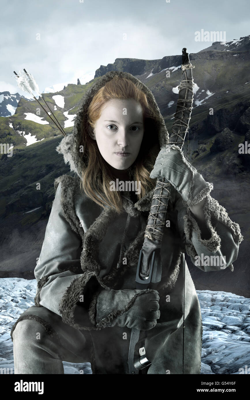 Wild girl archer in the snow with bow Stock Photo - Alamy