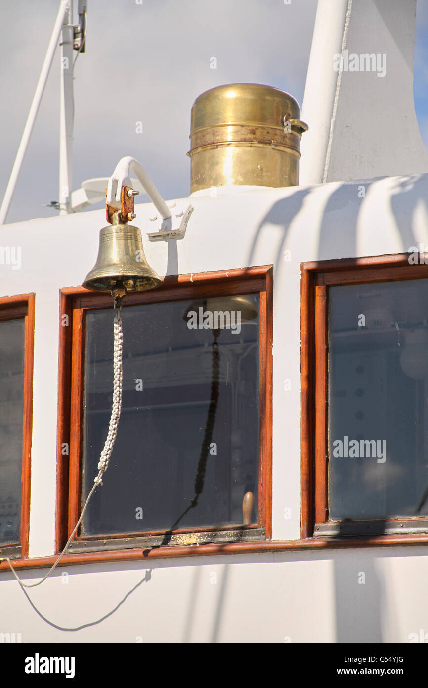 Ship bell outside wheelhouse on old boat Stock Photo - Alamy