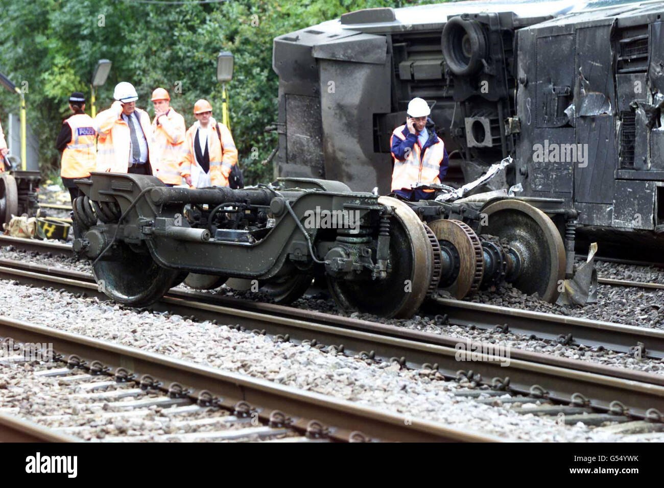 Rail crash investigators pick their way through the wreckage of the ...