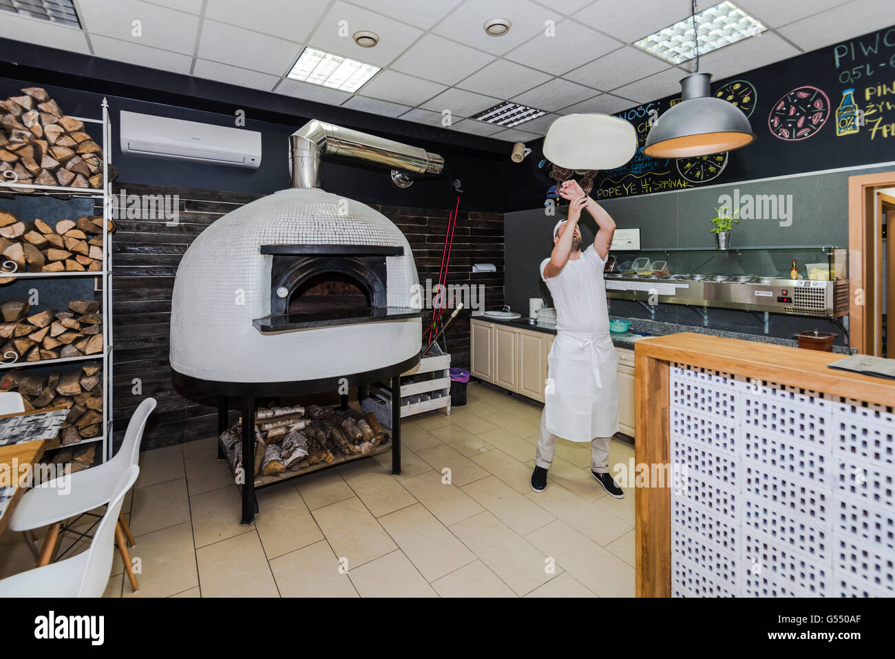 Young chef making traditional pizza dough in italian restaurant Stock ...
