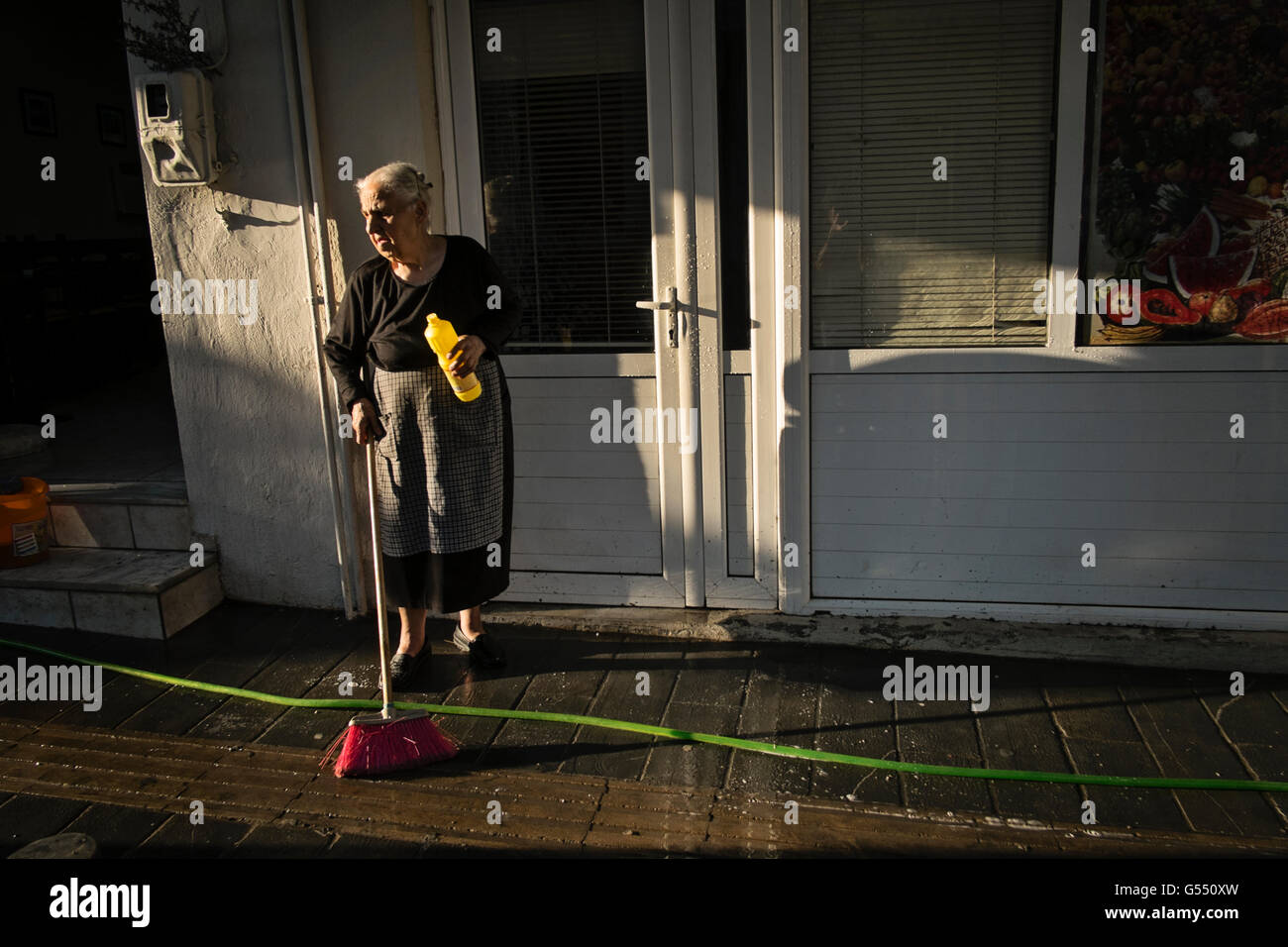 Elderly woman sweeping outside old hi-res stock photography and images ...