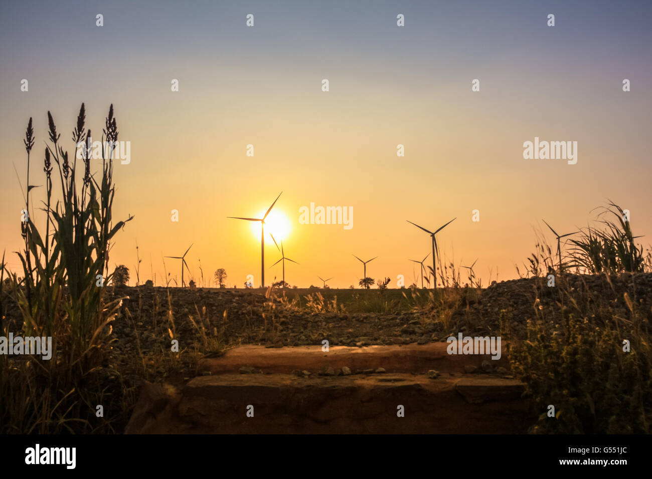 Sunset at wind turbine farm in Thailand Stock Photo - Alamy