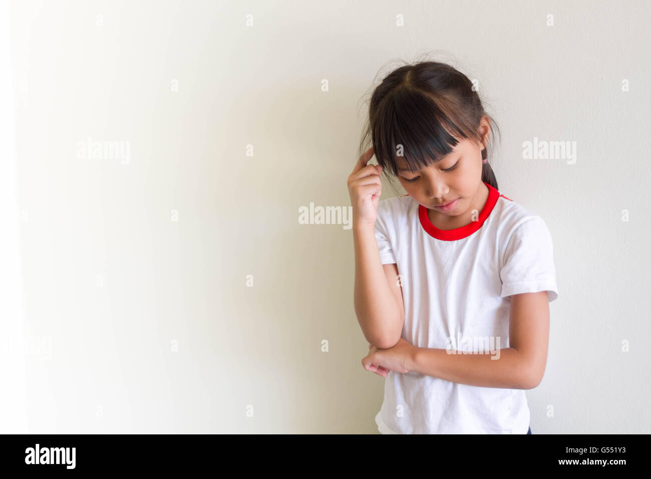 Asian girl kid is thinking for something Stock Photo - Alamy