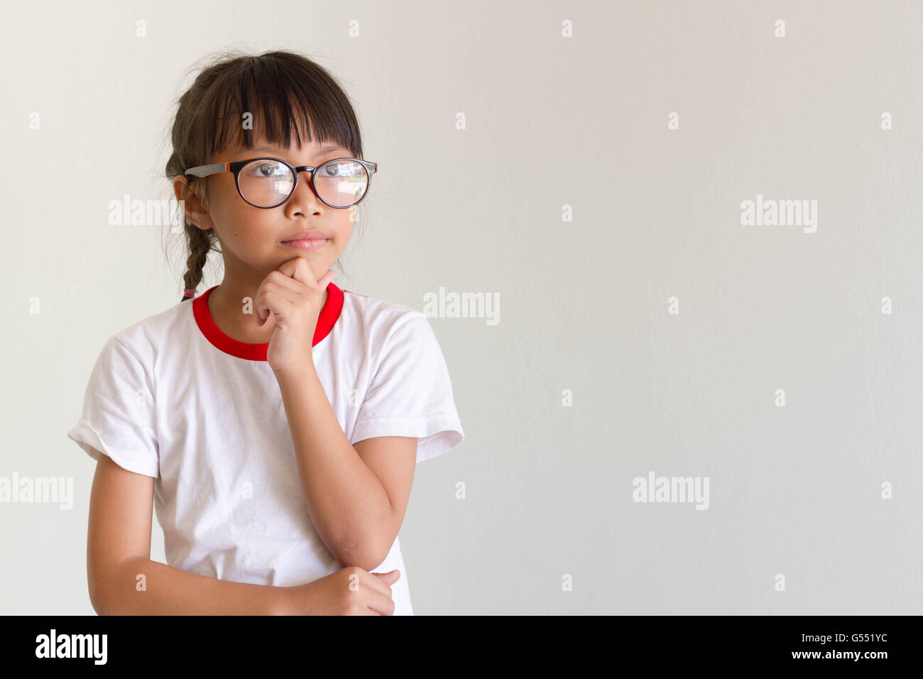 Asian girl kid is thinking for something Stock Photo - Alamy