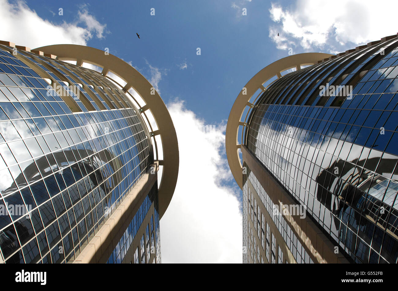 Architecture tall circular glass office buildings soaring up into a ...