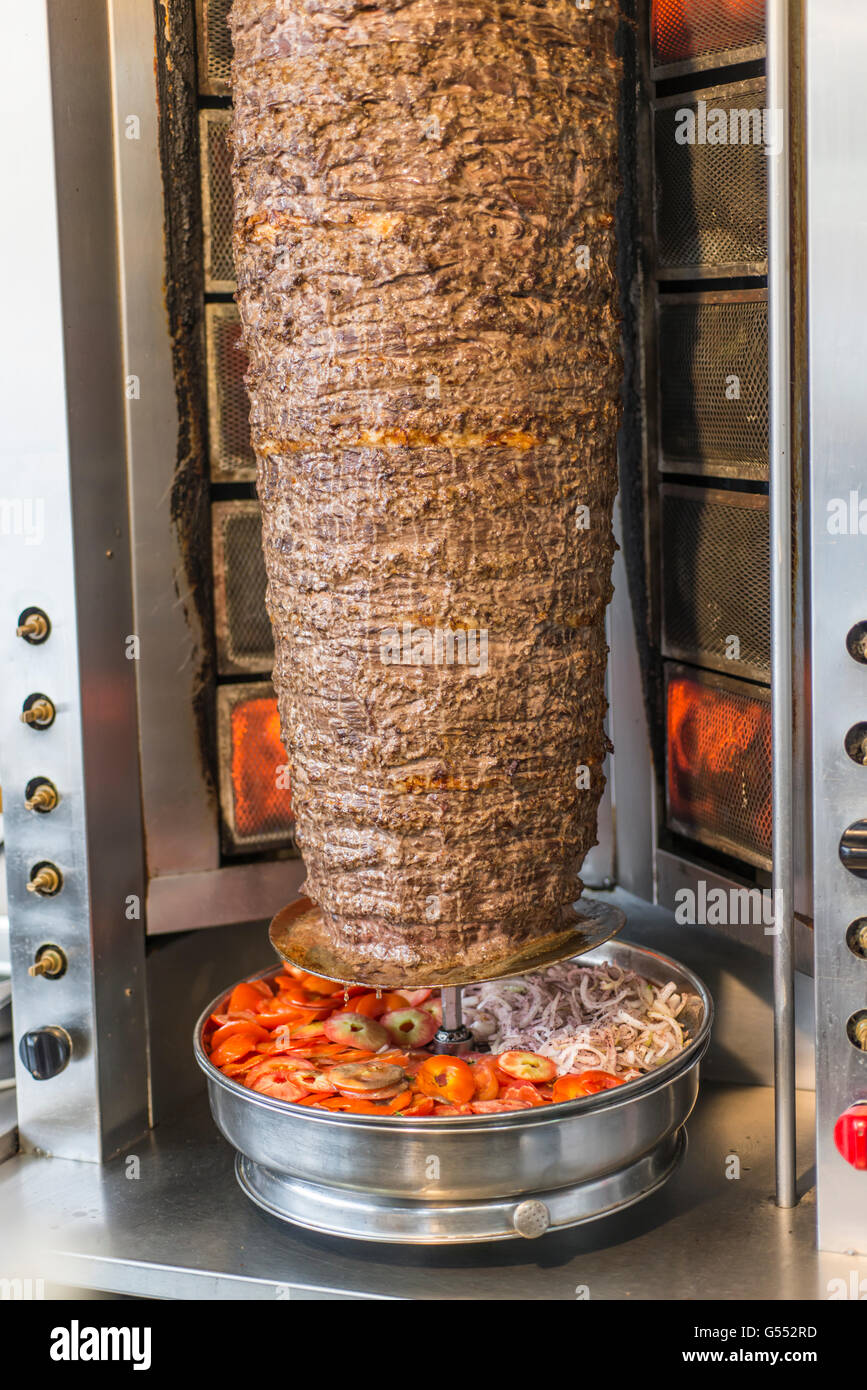 Shawarma spit with onions and tomatoes slices Stock Photo - Alamy