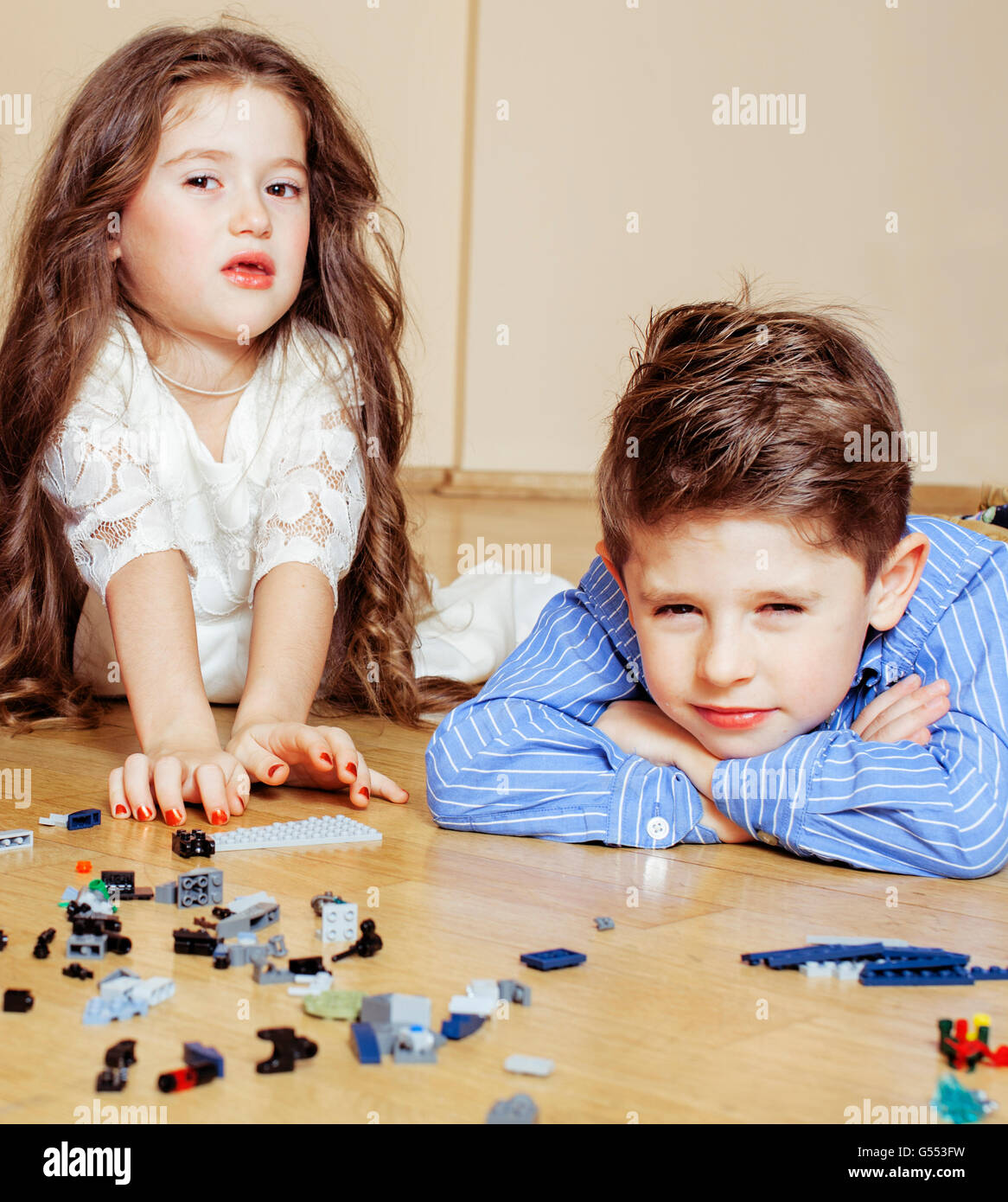 funny cute children playing lego at home, boys and girl smiling, first ...