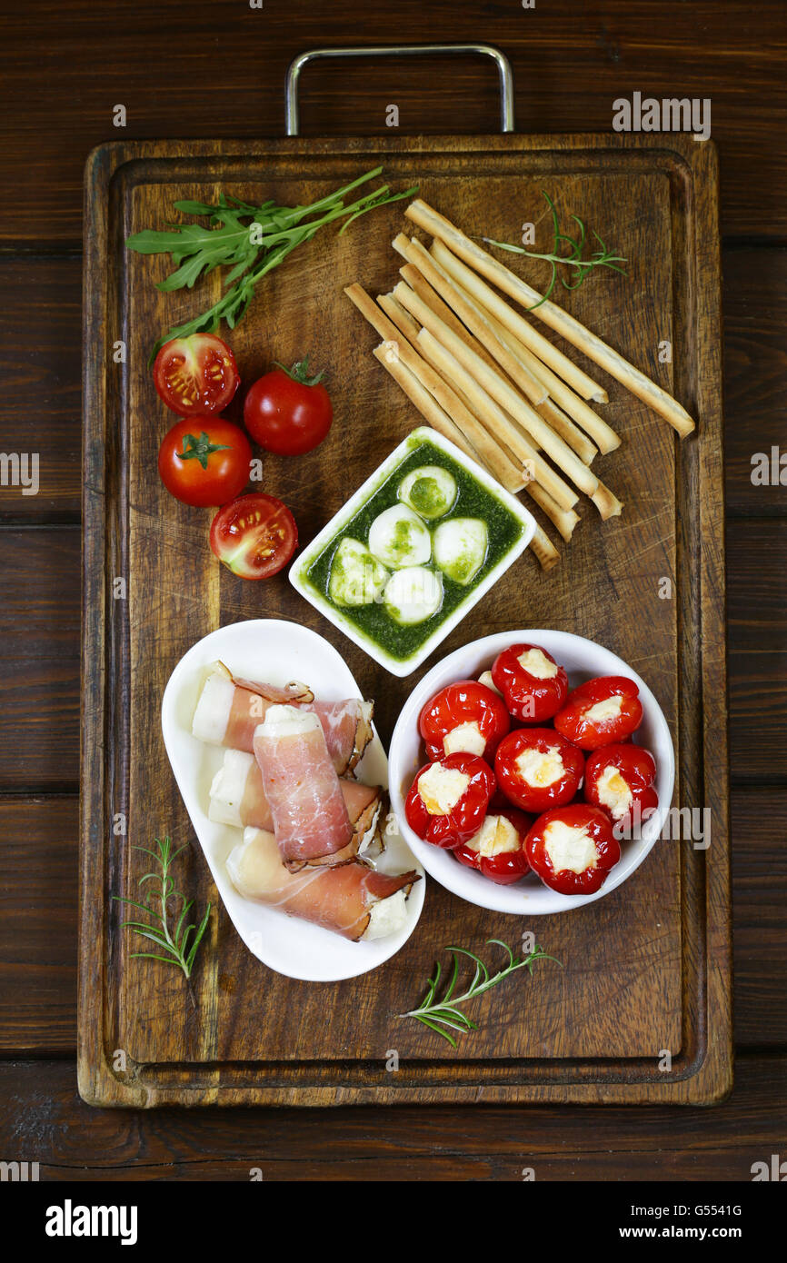 Italian appetizer antipasti made dish - ham, cheese, peppers Stock ...