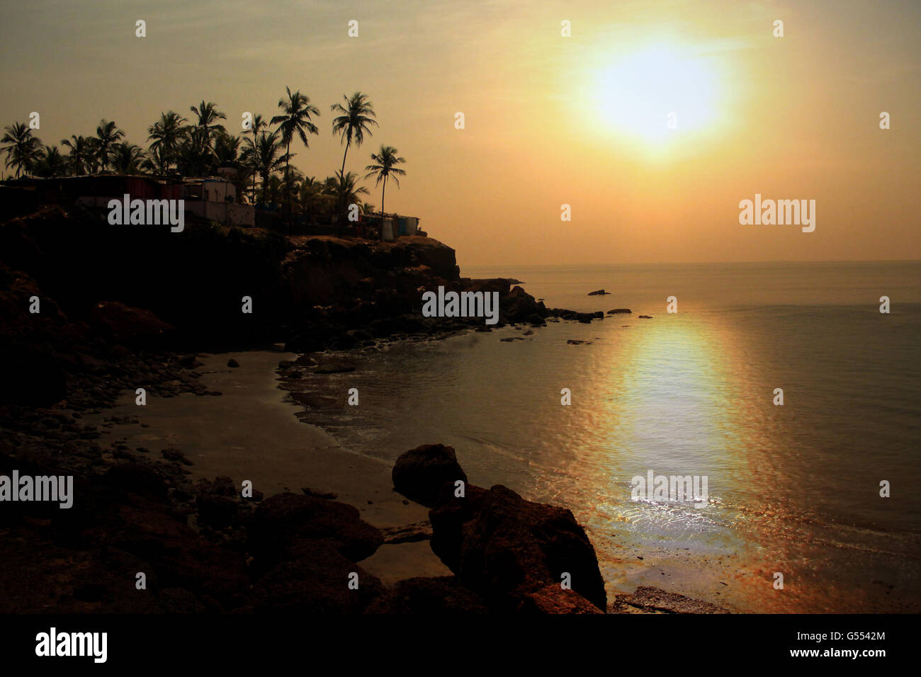 A background with a view of a beautiful sunset on the rocky beach in ...