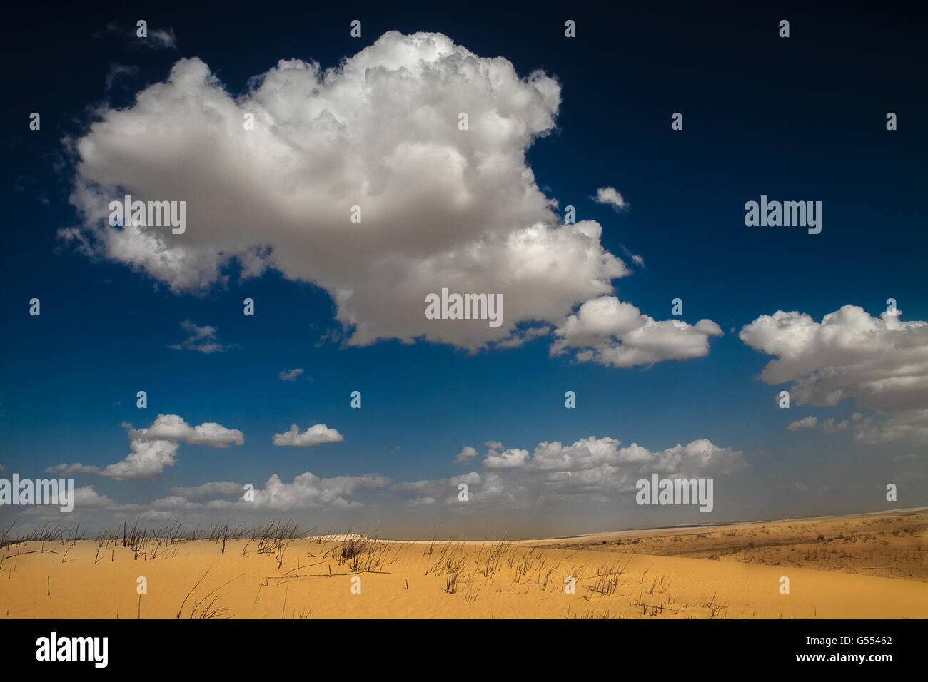 Clouds over a desert landscape Stock Photo - Alamy