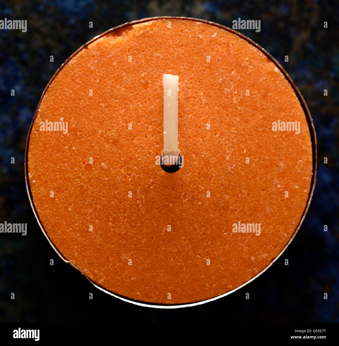 An orange tea light candle close up macro Stock Photo - Alamy