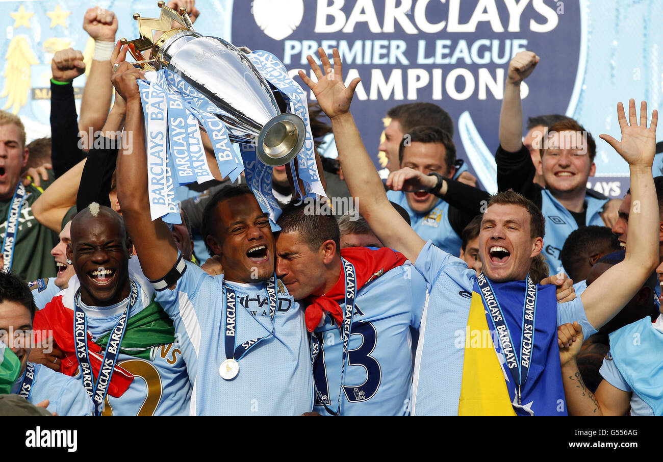 Manchester City's captain Vincent Kompany lifts the trophy as he ...