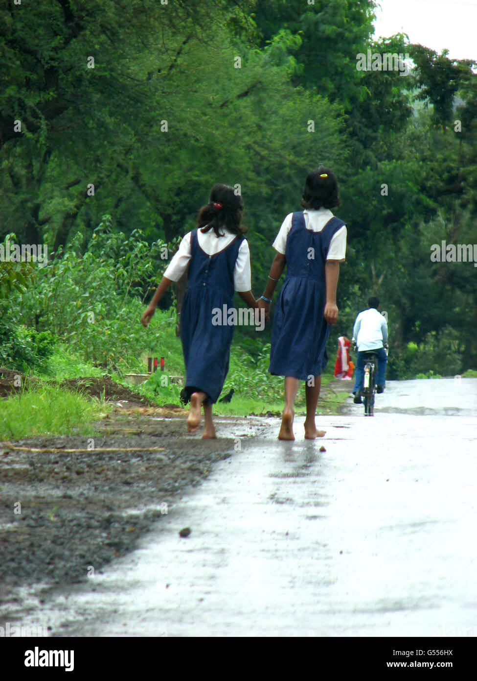 Poor barefooted Indian girls running to school in rains for not having ...