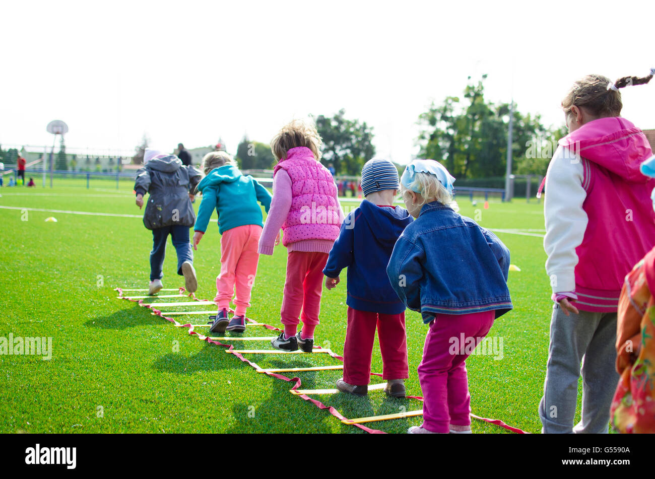 Kids together in jumping competition Stock Photo - Alamy