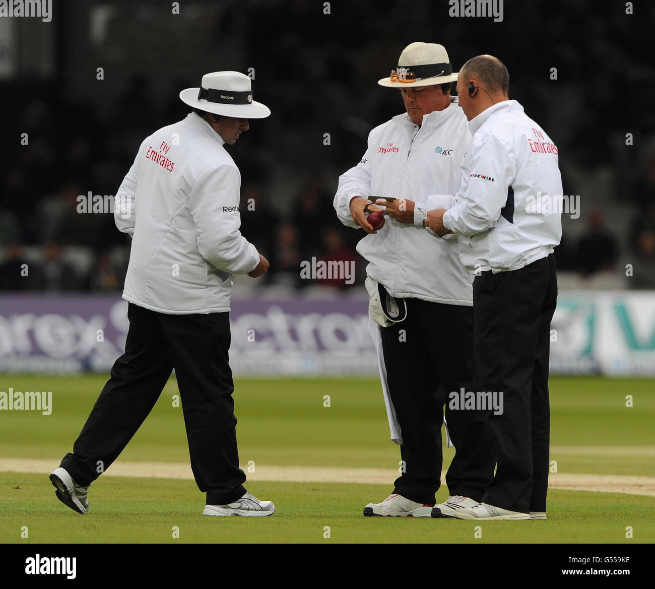 Umpires Marais Erasmus (centre) and Aleem Dar (left) check the shape of ...