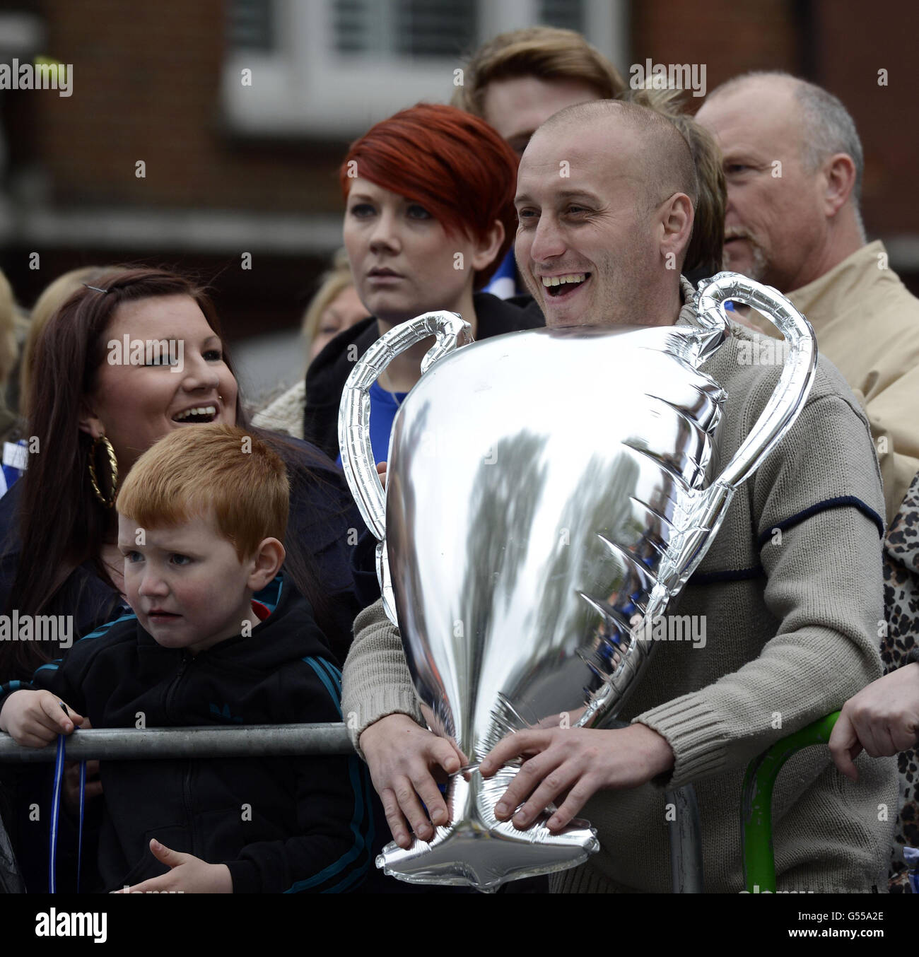 Chelsea fans wait for the FA Cup and UEFA Champions League trophy ...
