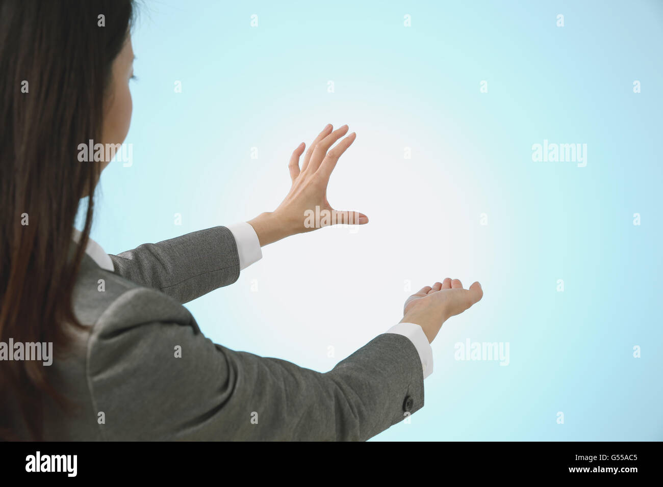 Japanese woman performing touch gesture Stock Photo - Alamy