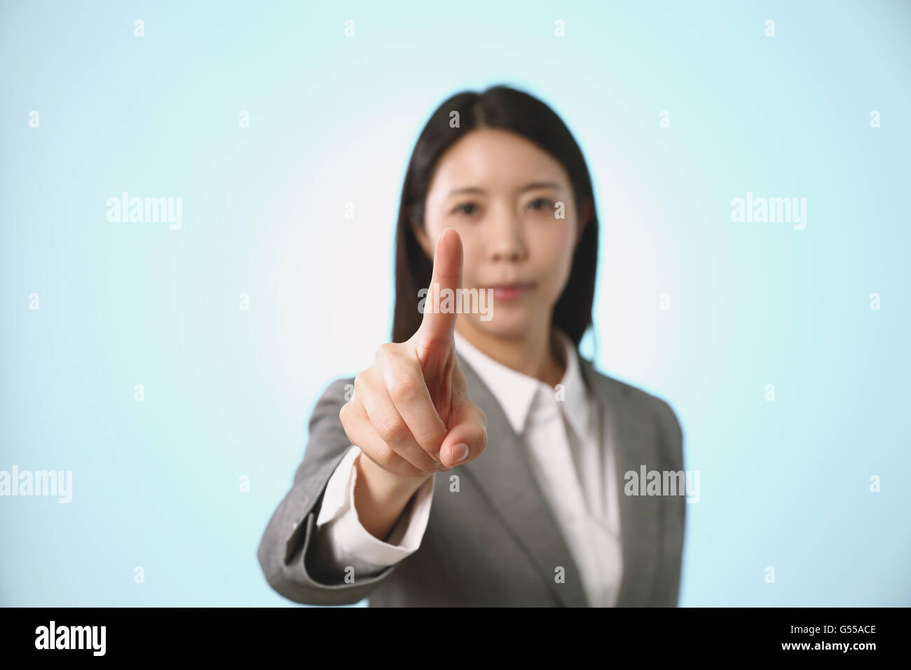 Japanese woman performing touch gesture Stock Photo - Alamy